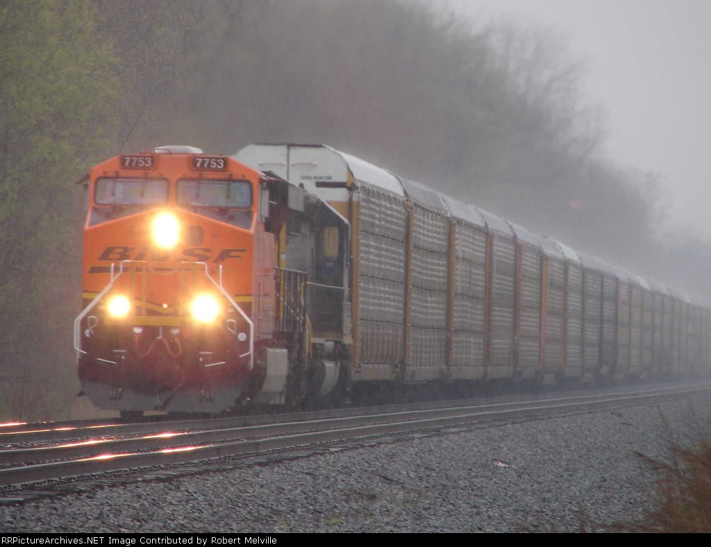 BNSF 7753 leads autoracks eastbound in a heavy rain near MP 379